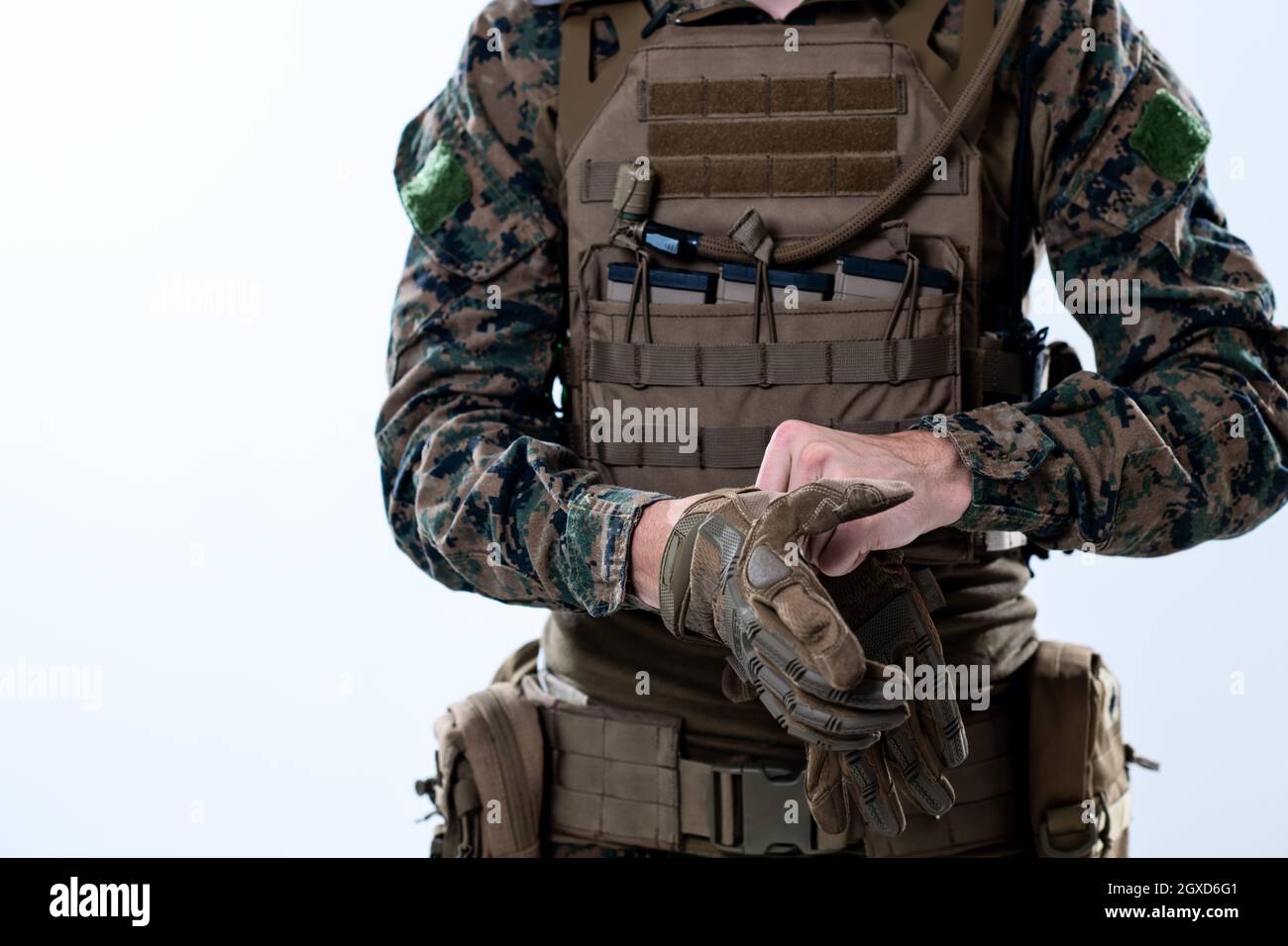 closeup of modern warfare soldier hands putting protective battle ...