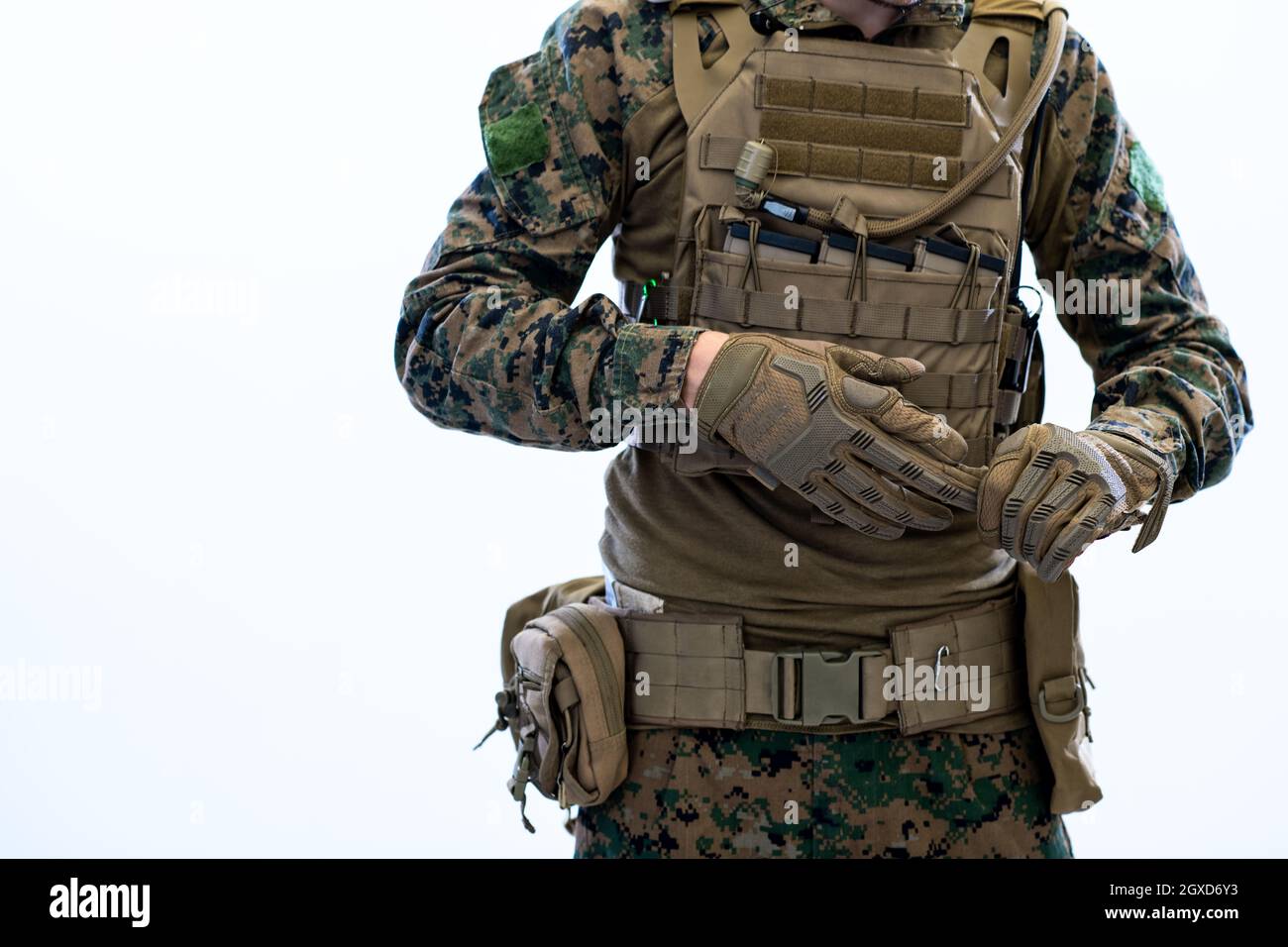 closeup of modern warfare soldier hands putting protective battle ...