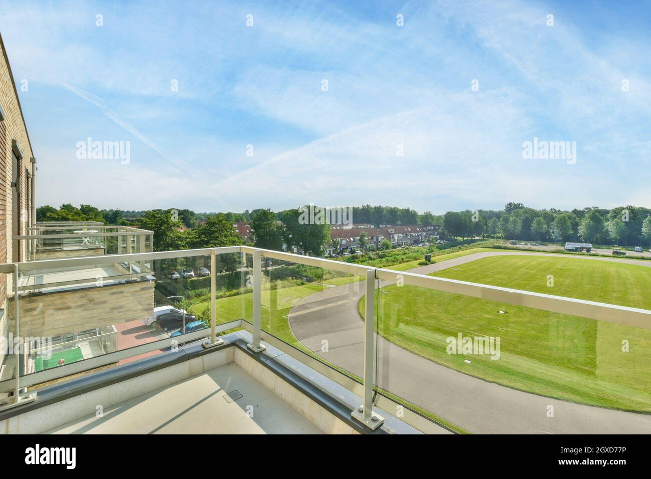 View from balcony of modern apartment building on trees growing along ...