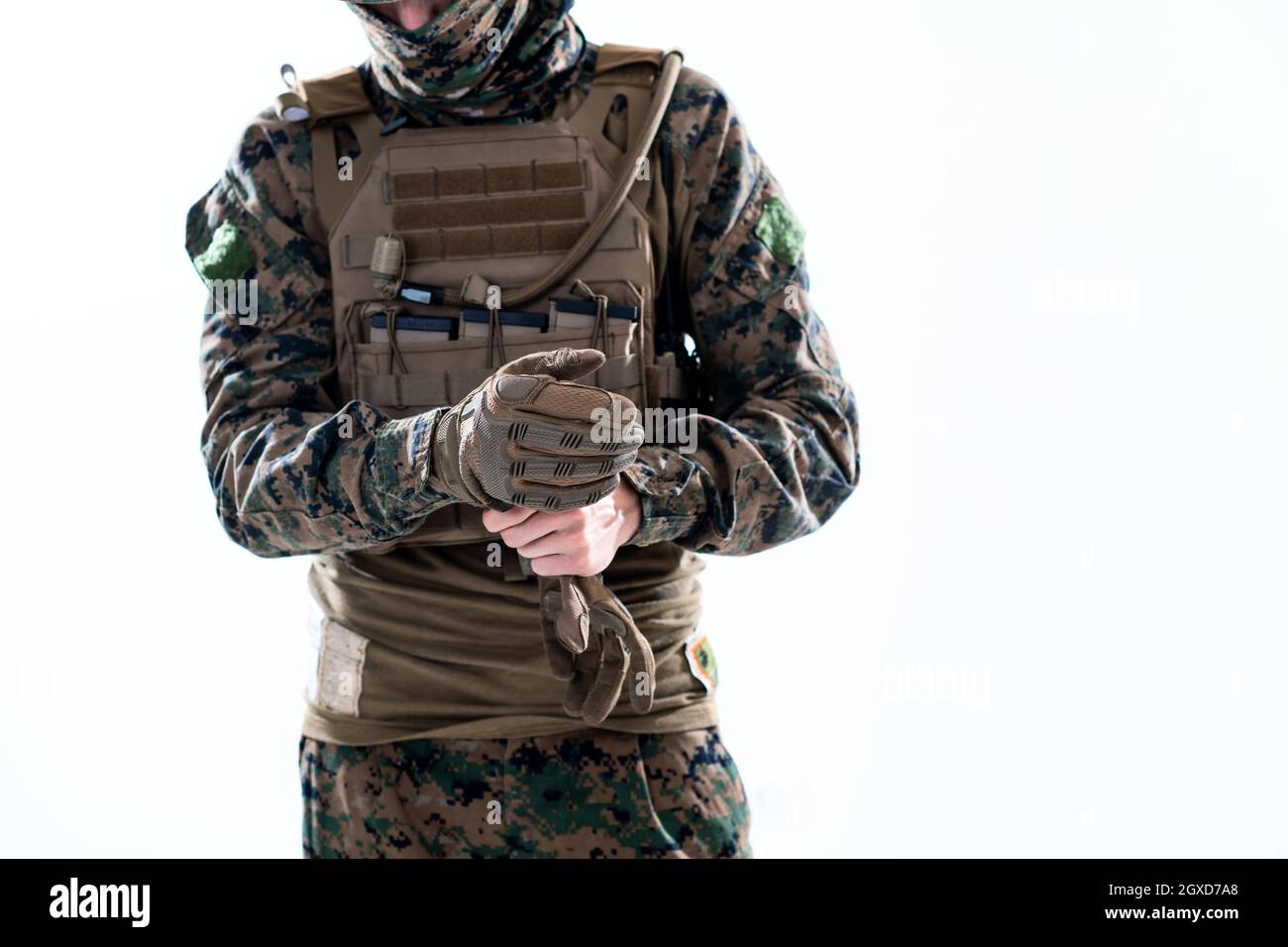 closeup of modern warfare soldier hands putting protective battle ...