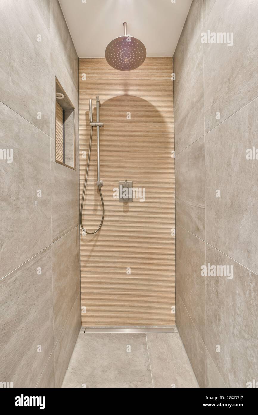 Stylish interior of bathroom with empty shower and light walls in ...
