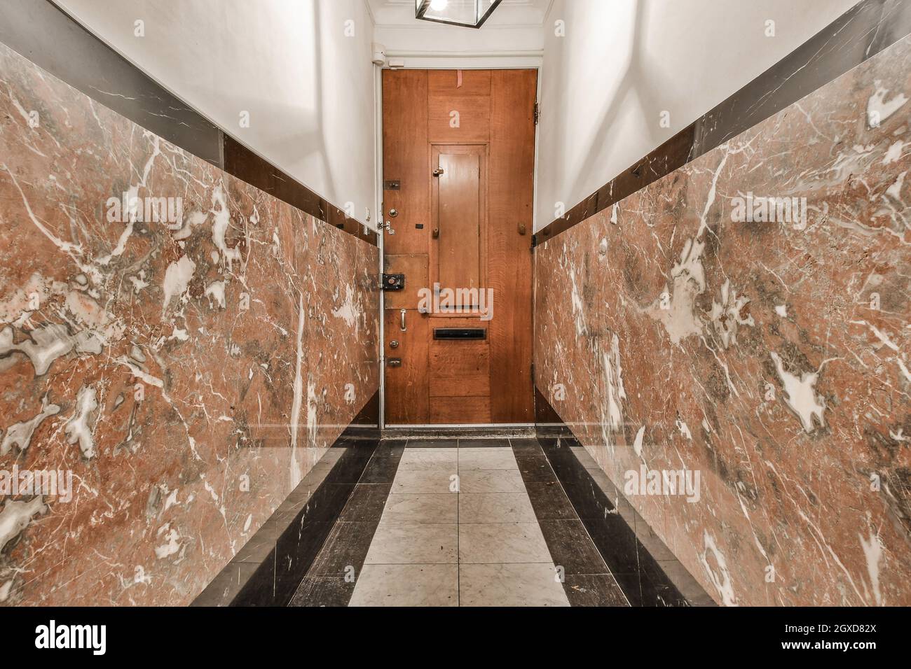 Perspective view of interior of long hallway with tiled walls and floor ...
