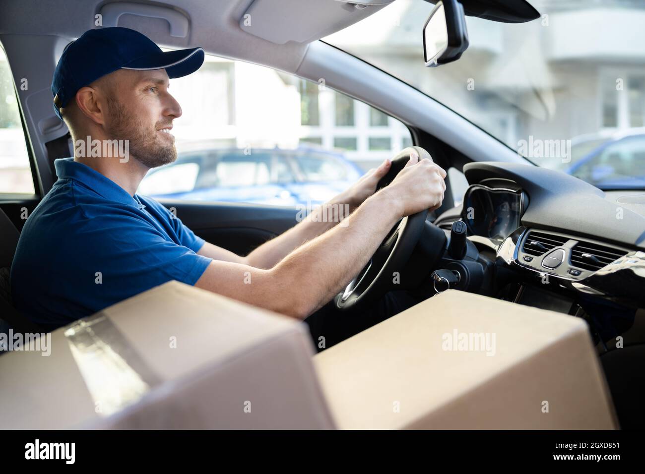 Delivery Worker Man In Uniform In Car Stock Photo - Alamy