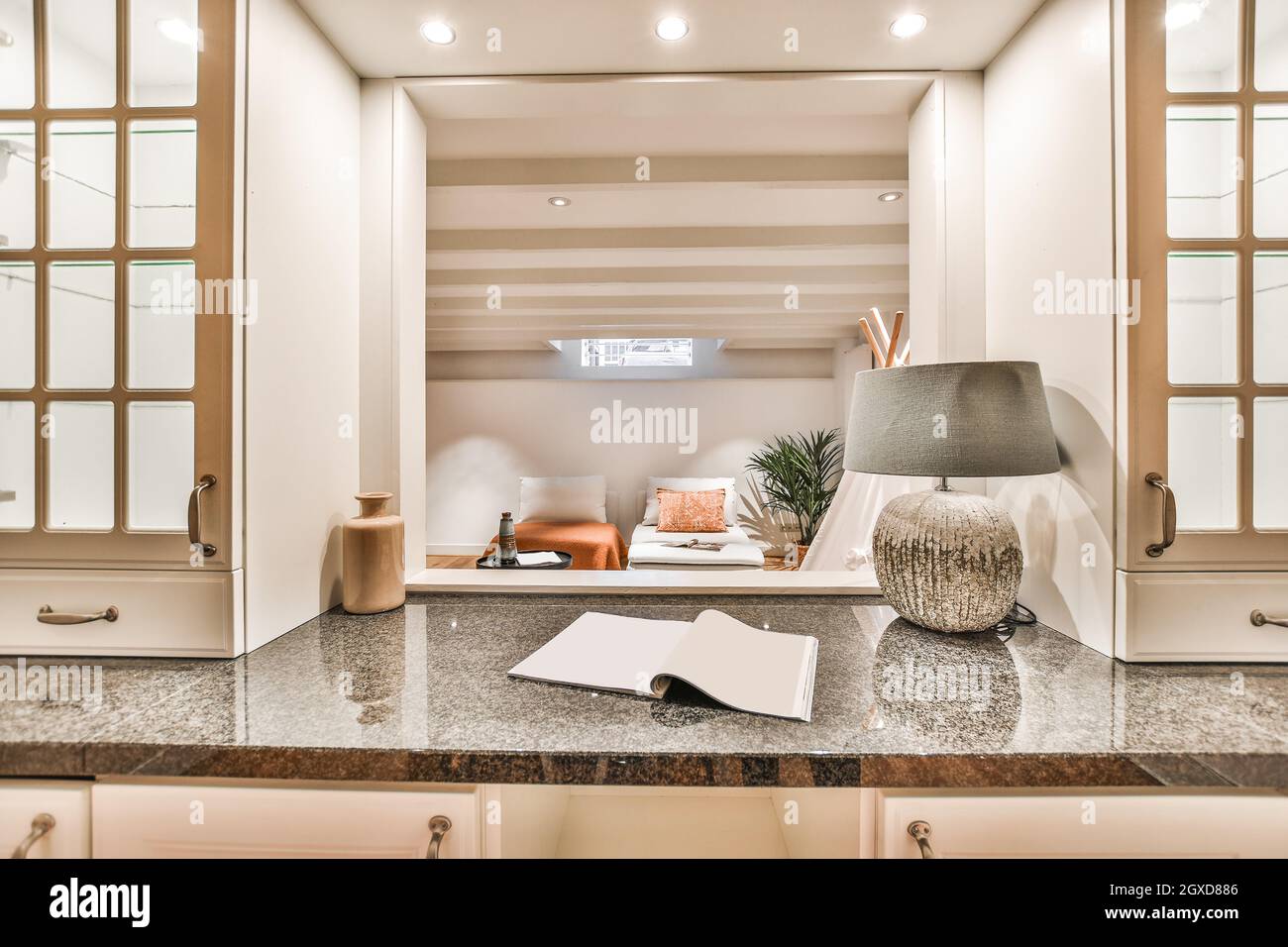 Through window of contemporary interior of spacious kitchen with dining ...