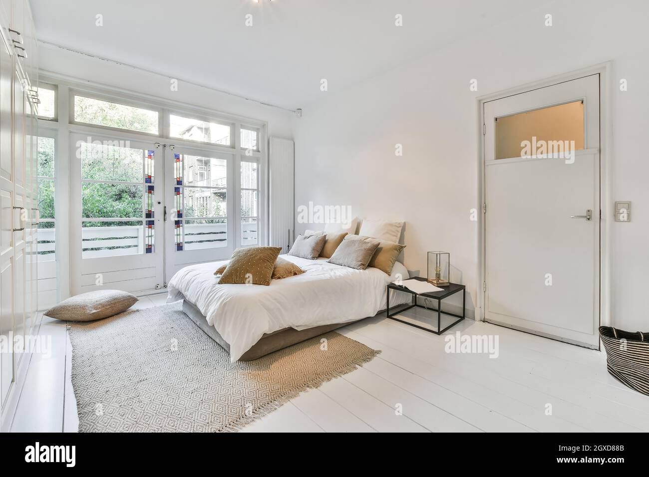 Interior of contemporary bedroom with comfortable bed and empty shelves ...