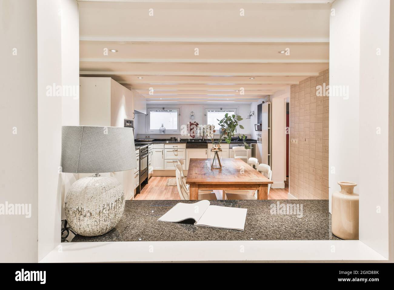Through window of contemporary interior of spacious kitchen with dining ...