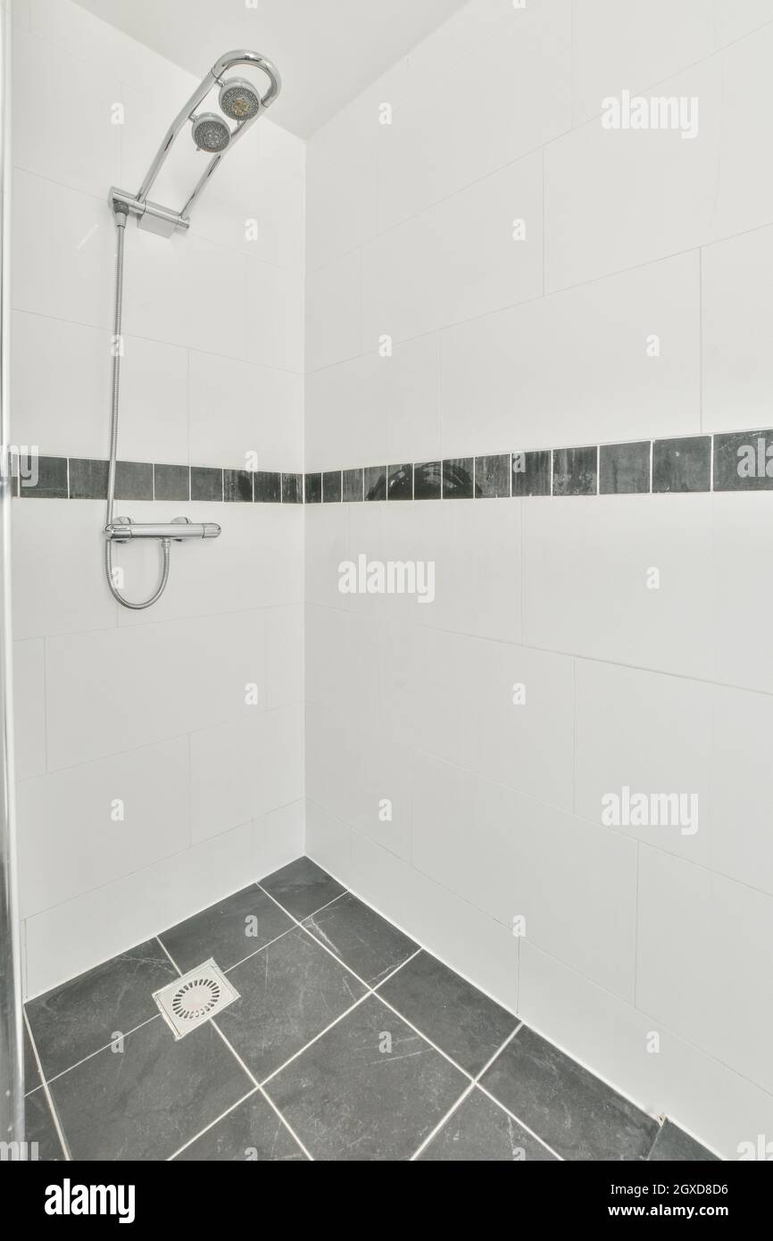 Interior of bathroom with empty shower cabin with white tiled walls in ...