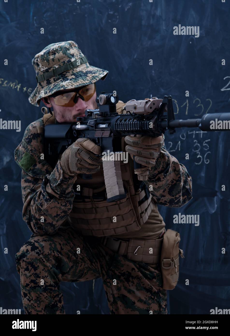 modern warfare american marines soldier in action while sneaking and aiming sniper riffle on ...