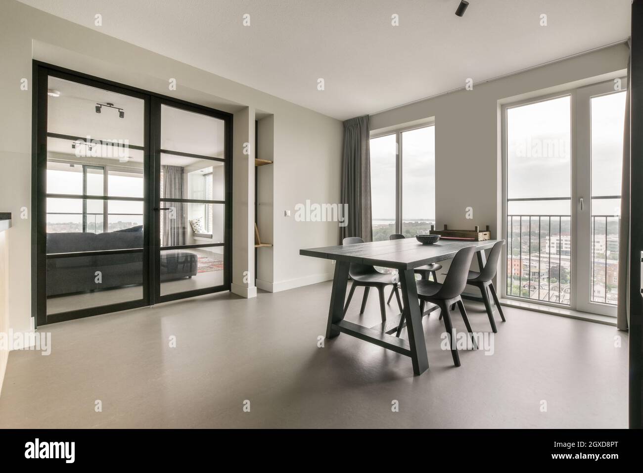 Contemporary apartment with spacious dining room with empty table and ...