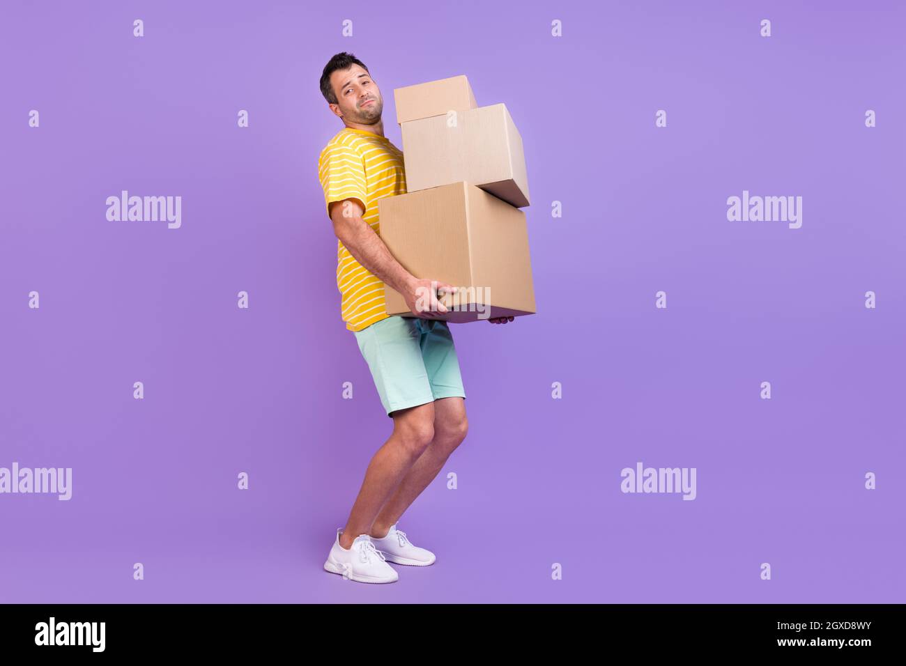 Full length body size photo man keeping heavy boxes delivery isolated ...