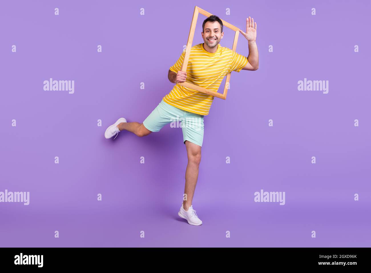 Full body photo of happy positive man wave hello make picture wooden ...