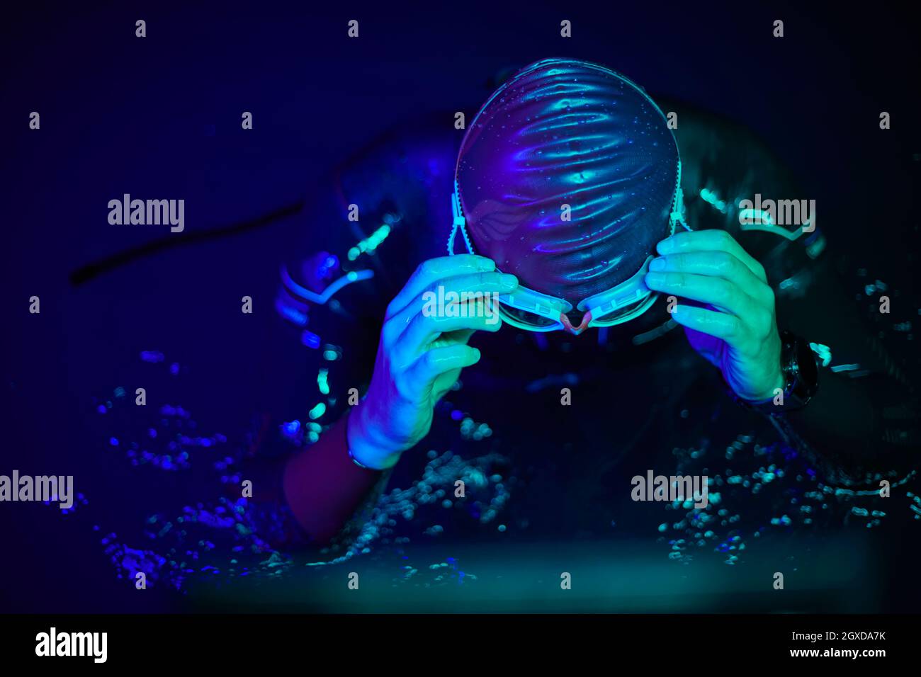 real triathlete swimmer having a break during hard training at lake on ...