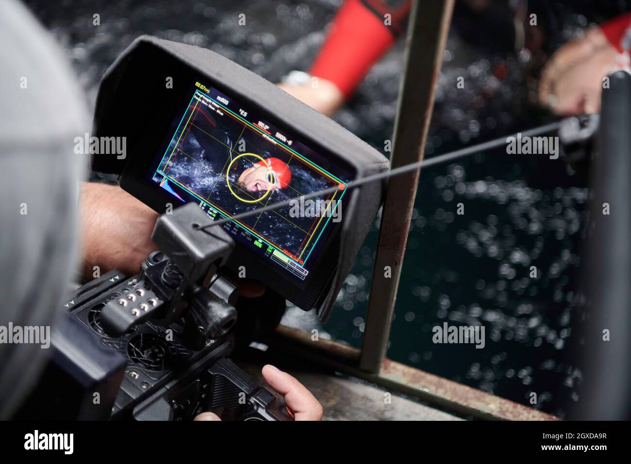 videographer with professional cinema camera taking sport action shot ...