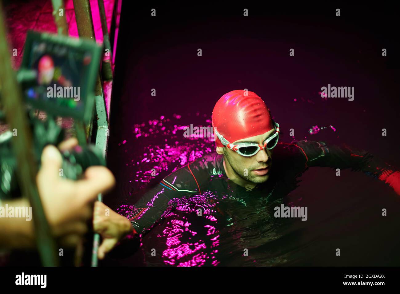 videographer with professional cinema camera taking sport action shot ...