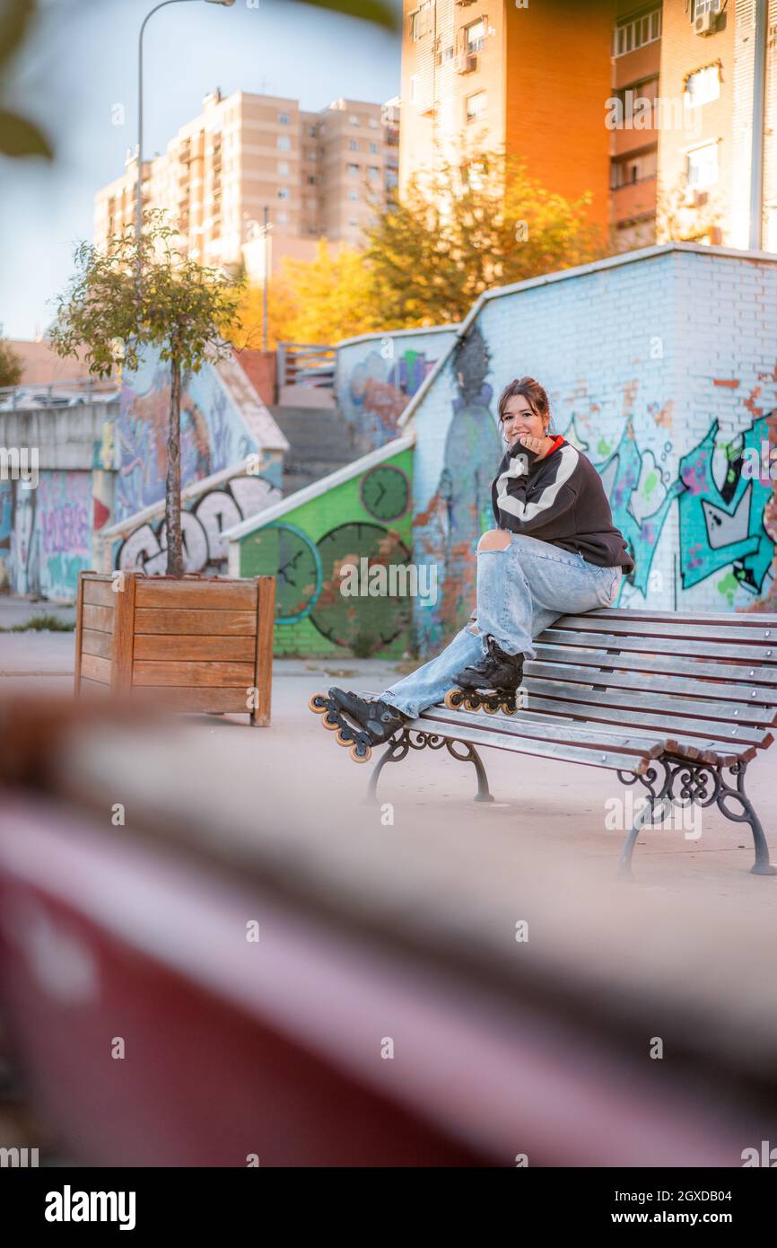 Full body of positive young female wearing casual black hoodie and ...