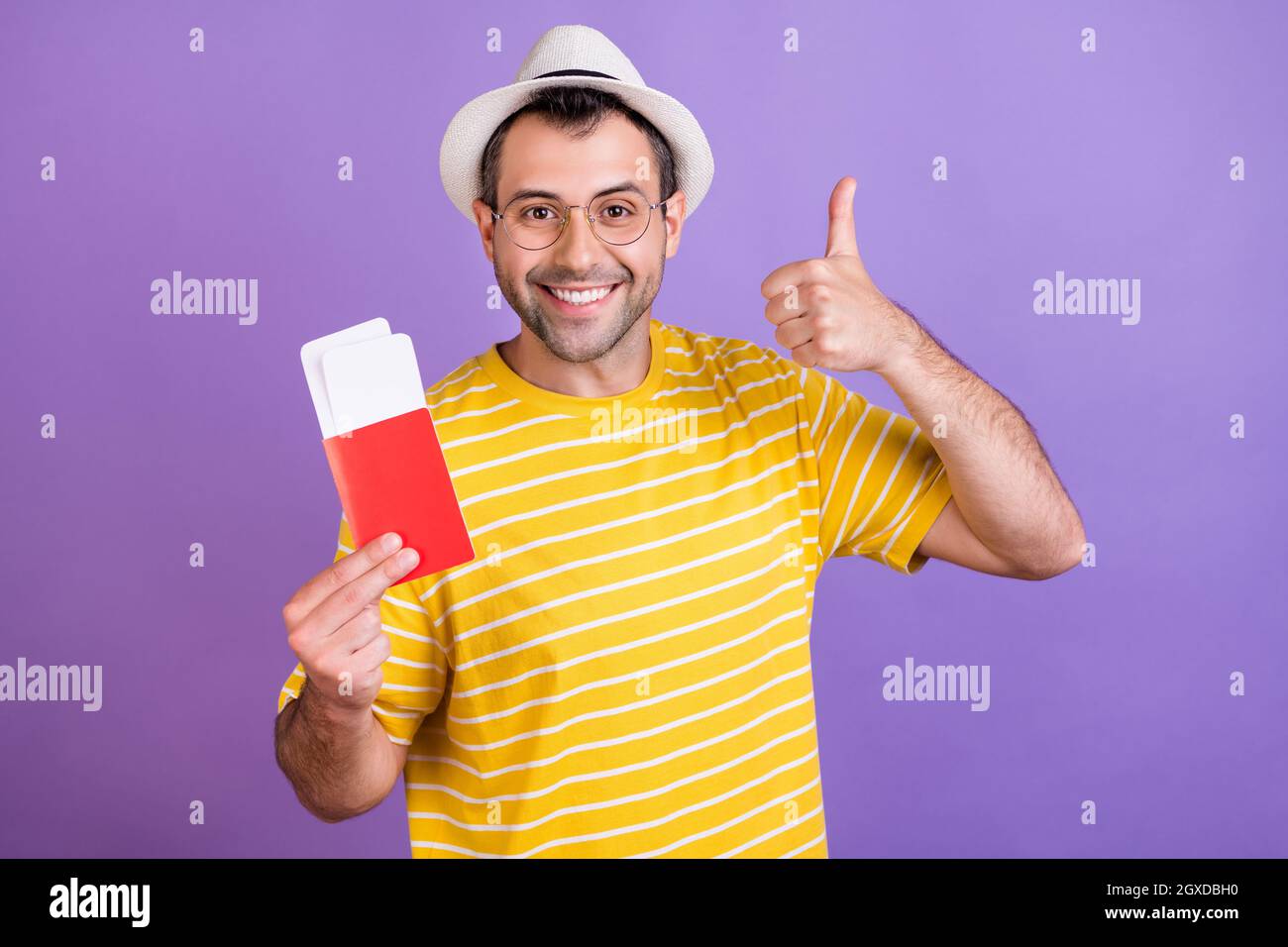 Photo of cheerful happy charming man hold hand ticket thumb up holiday ...