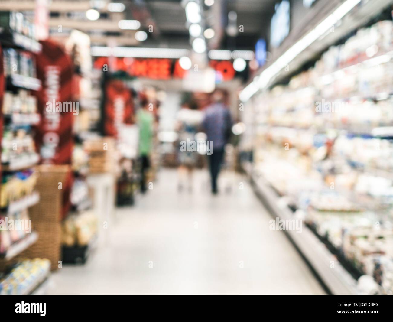 Abstract blurred supermarket aisle with colorful shelves and ...