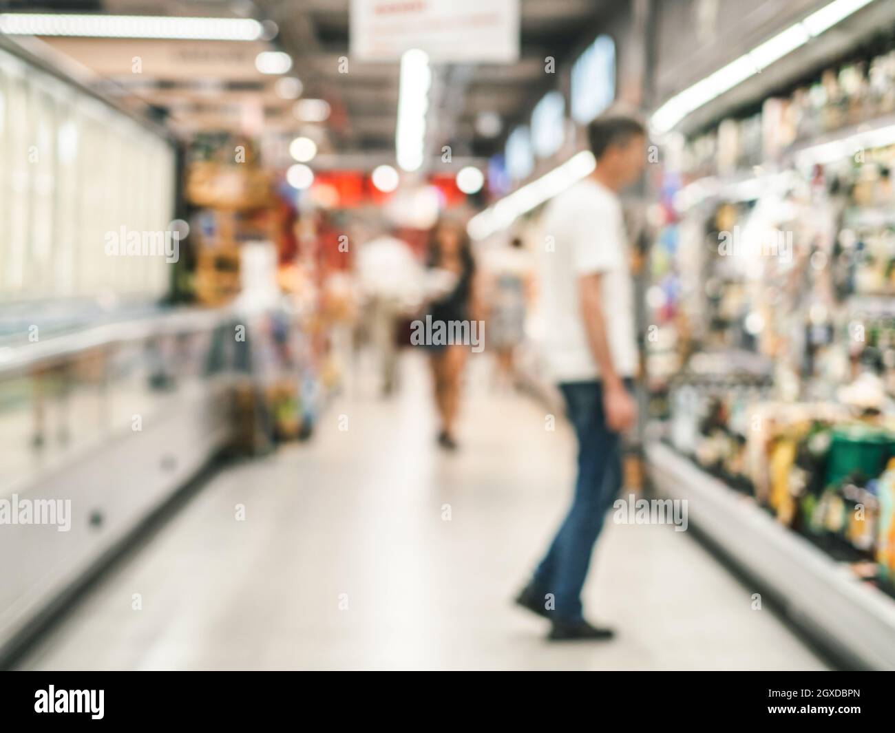 Abstract blurred supermarket aisle with colorful shelves and ...