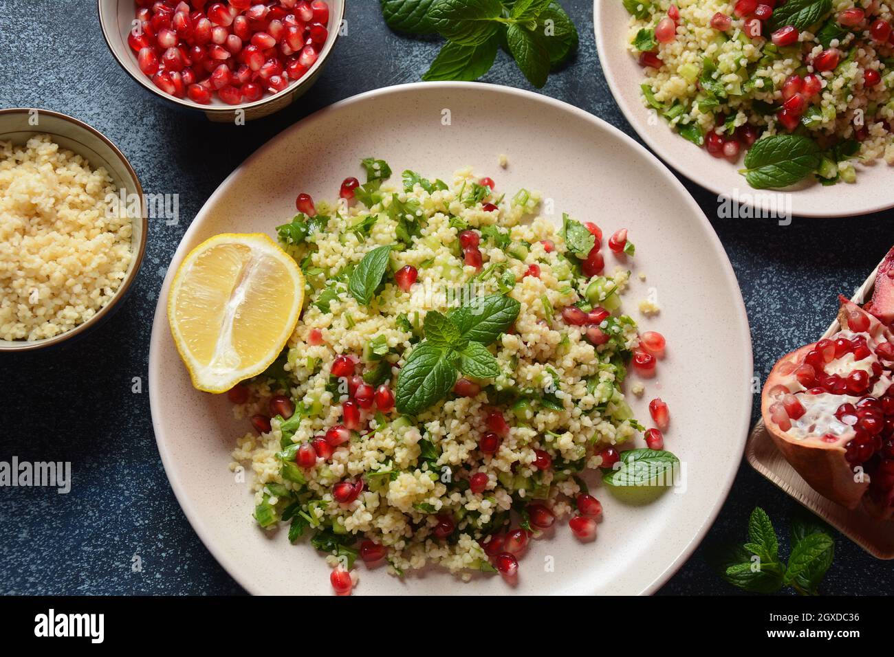 Healthy salad with couscous, fresh mint, cucumber, pomegranate, lemon ...
