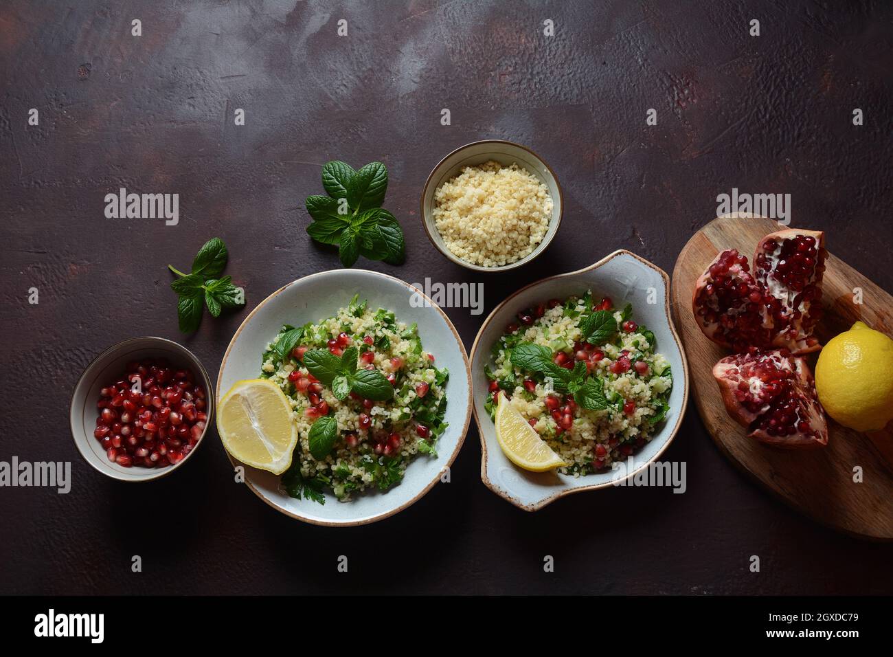 Healthy salad with couscous, fresh mint, cucumber, pomegranate, lemon ...