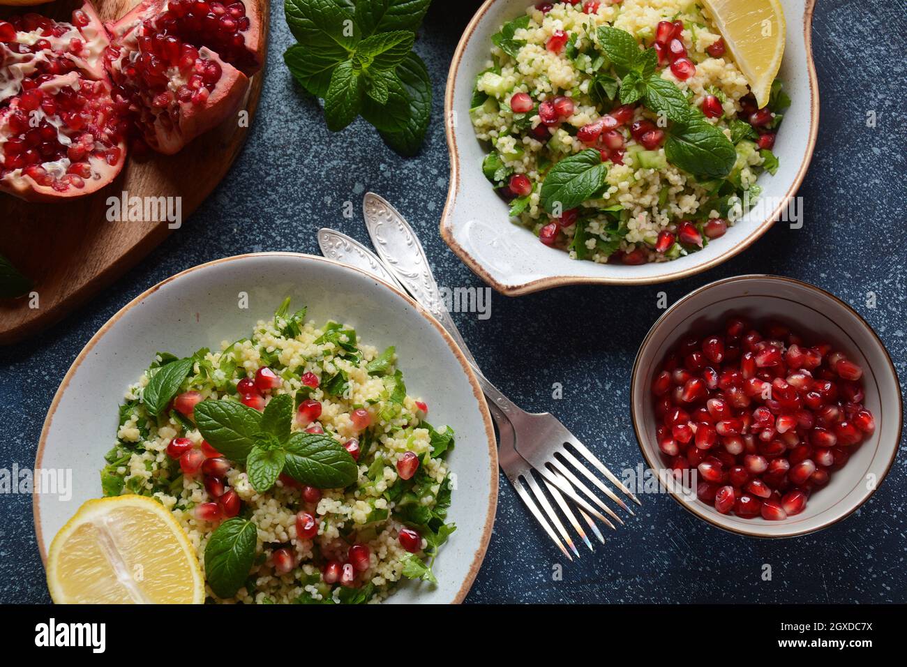 Healthy salad with couscous, fresh mint, cucumber, pomegranate, lemon ...