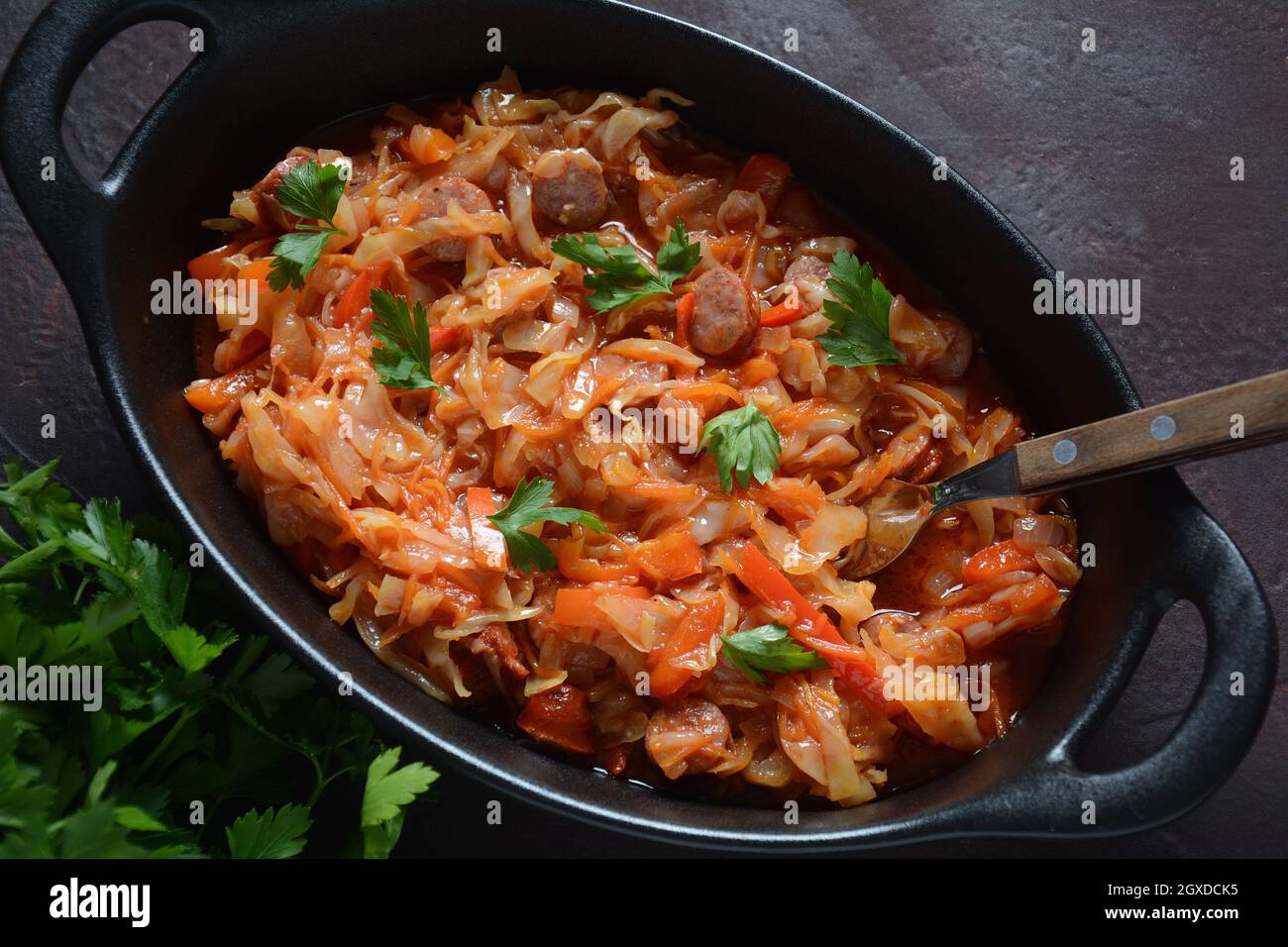 Cabbage stew with grilled sausage in tomato sauce - traditional dish of ...