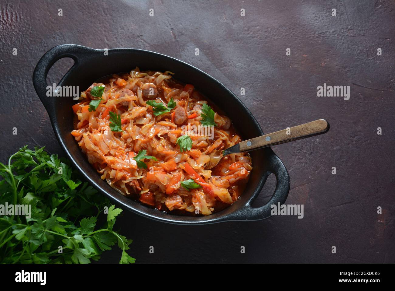 Cabbage stew with grilled sausage in tomato sauce - traditional dish of ...