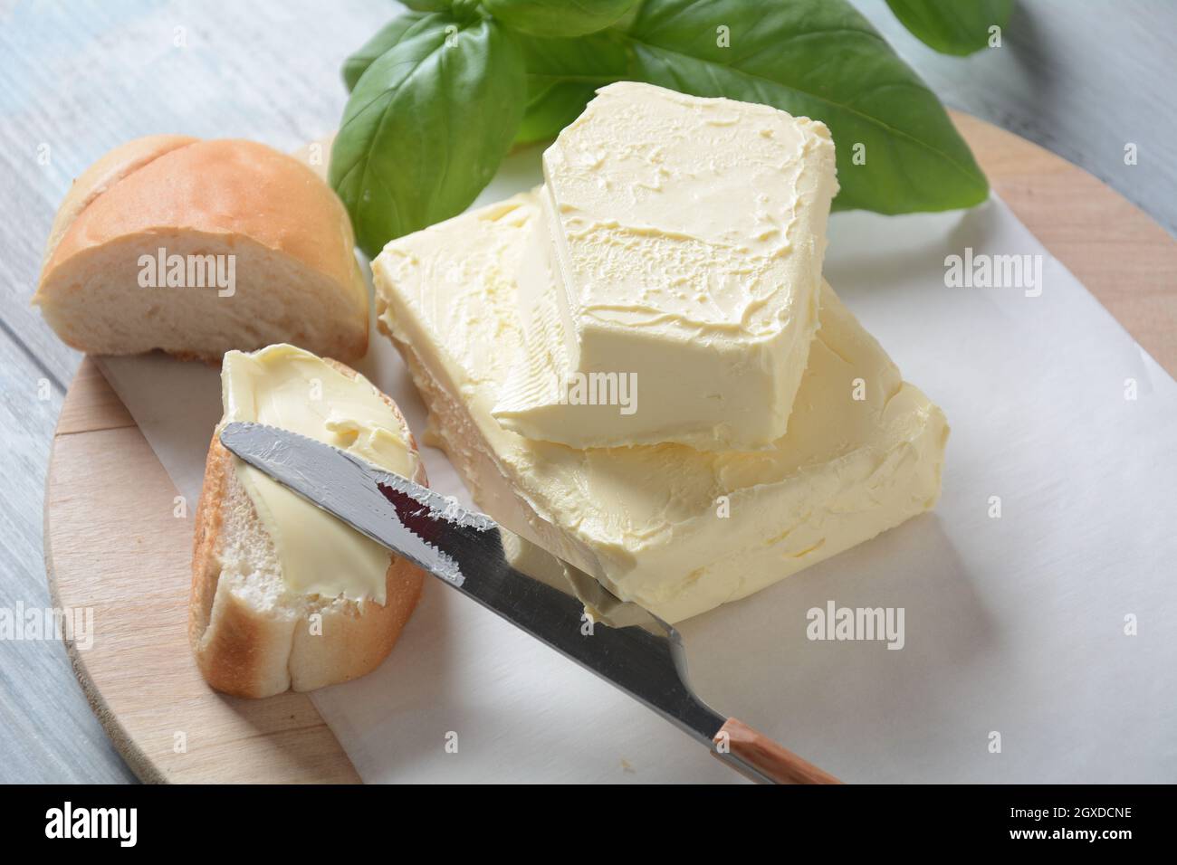Butter. Slice of butter with basil Stock Photo - Alamy