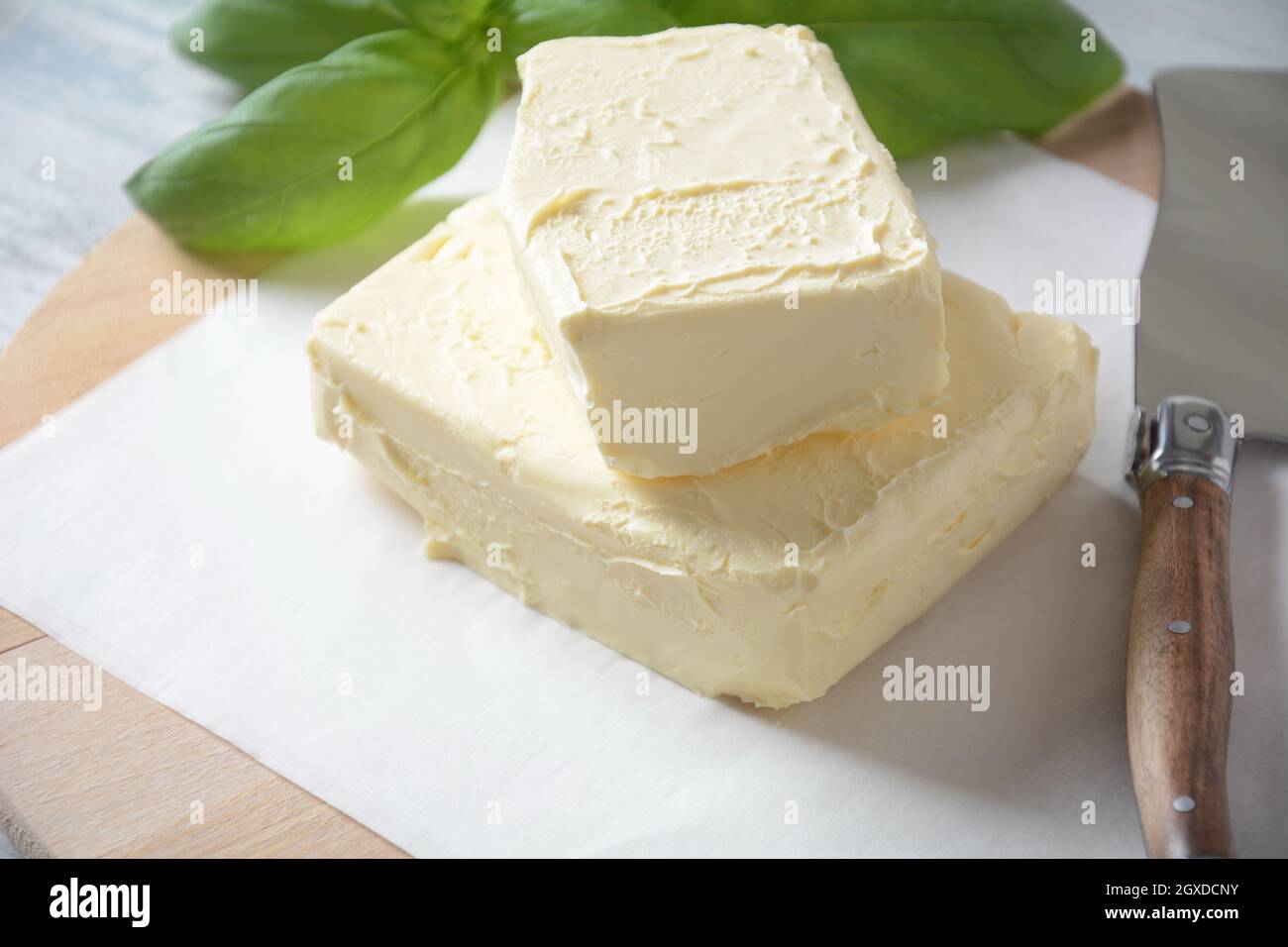 Butter. Slice of butter with basil Stock Photo - Alamy