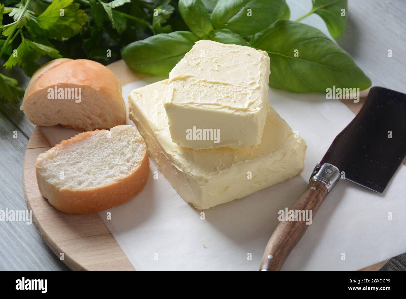 Butter. Slice of butter with basil Stock Photo - Alamy