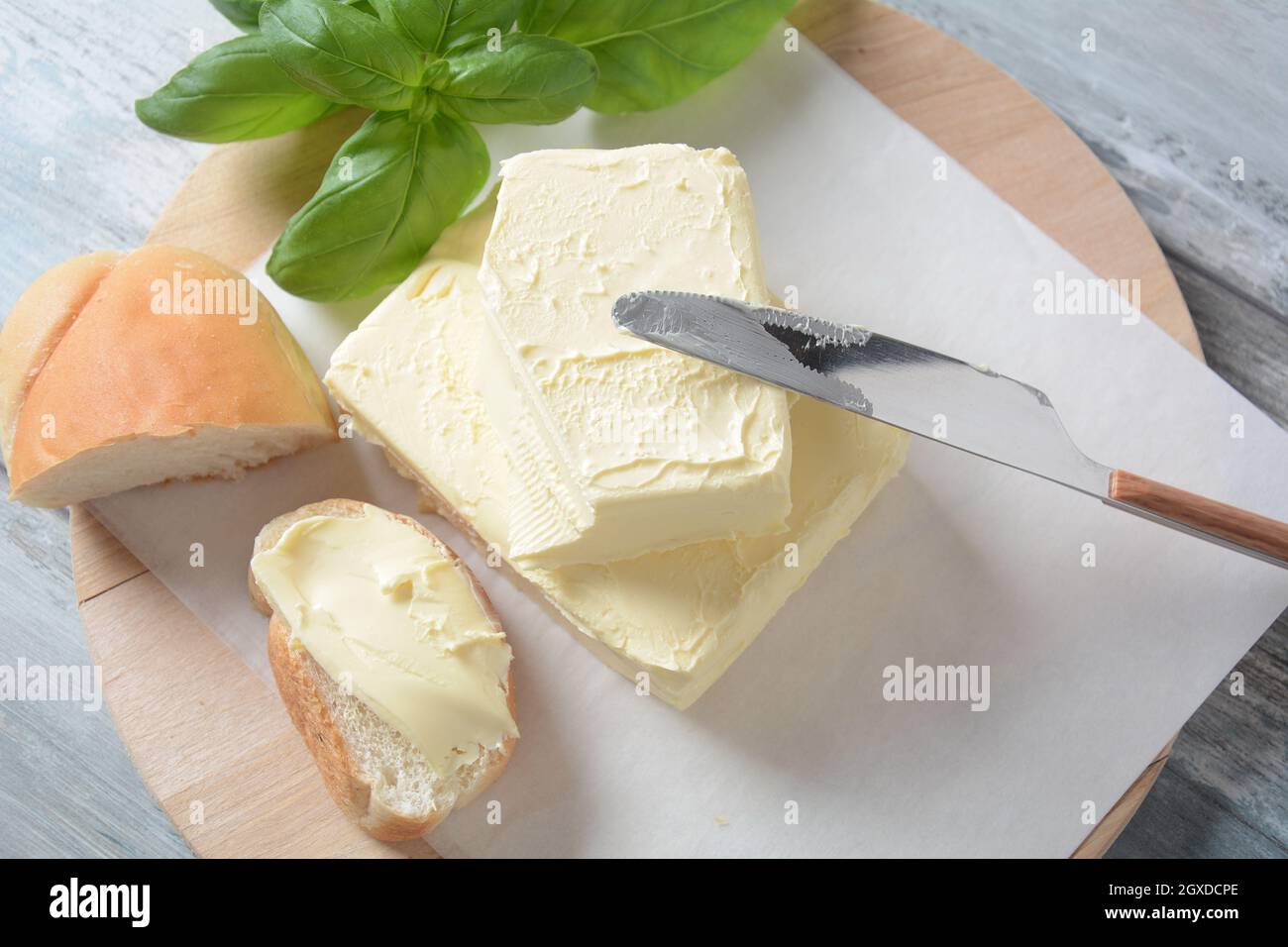 Butter. Slice of butter with basil Stock Photo - Alamy