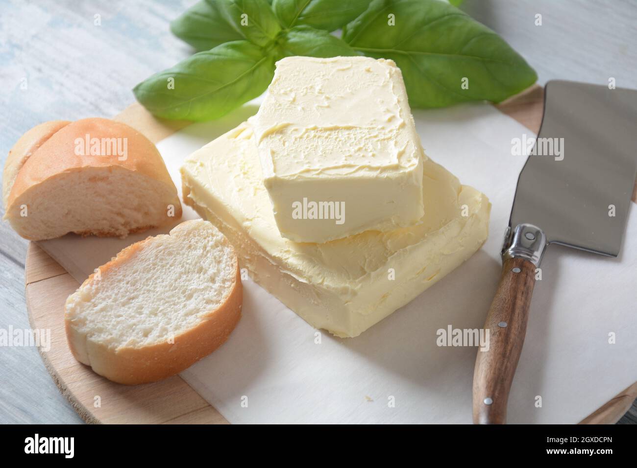 Butter. Slice of butter with basil Stock Photo - Alamy