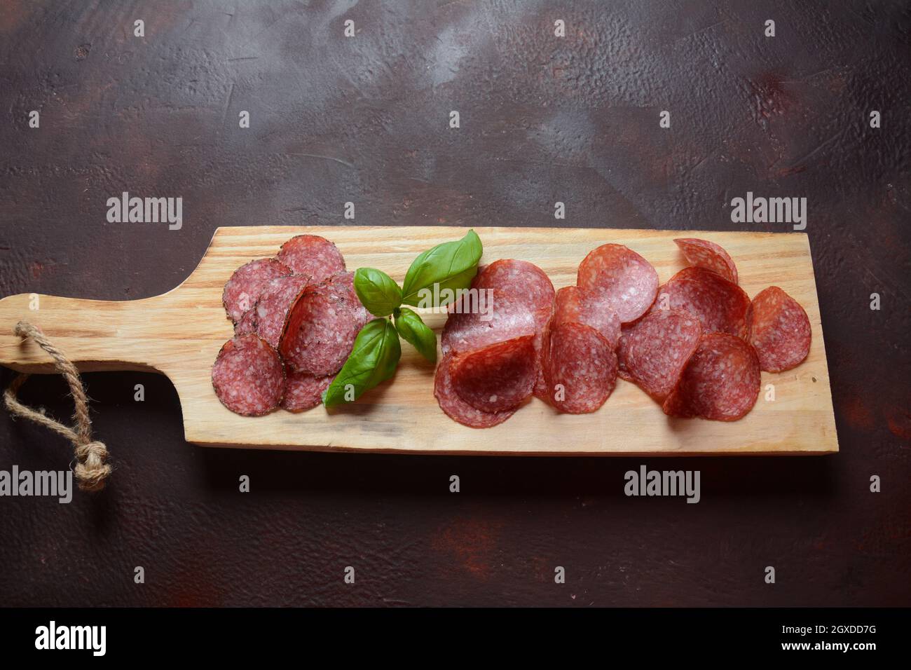 Sliced salami on cutting board Stock Photo - Alamy