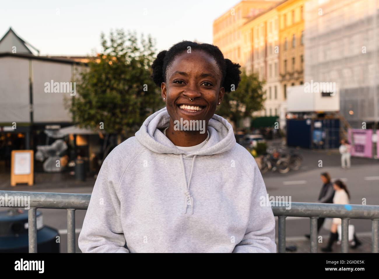 Delighted African American androgynous female smiling widely while ...