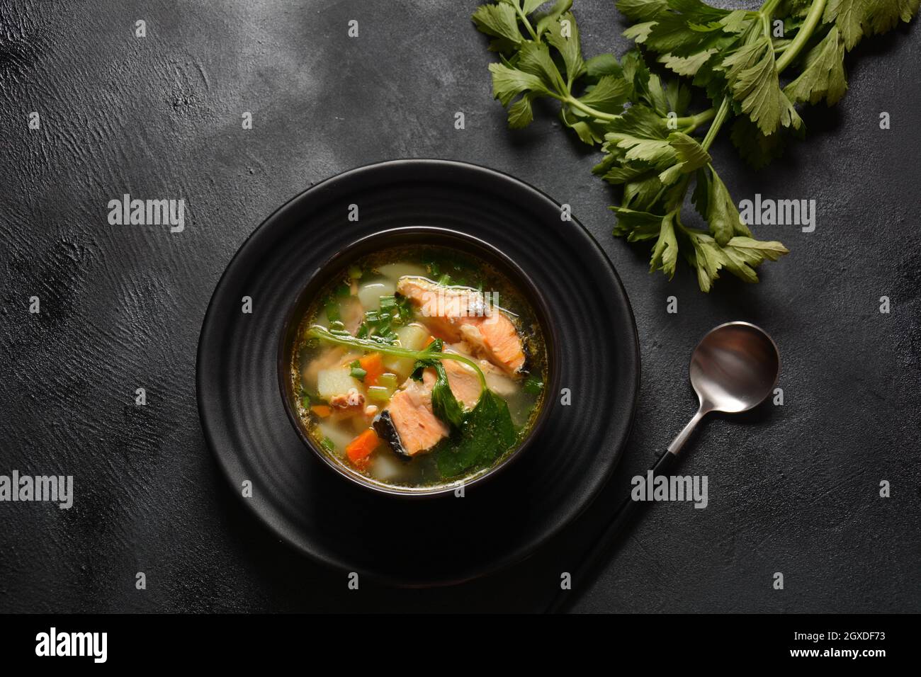 Fresh fish soup on black background. Salmon soup Stock Photo - Alamy Fresh fish soup on black background. Salmon soup Stock Photo - Alamy
