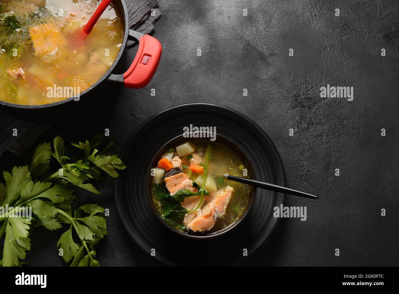 Fresh fish soup on black background. Salmon soup Stock Photo - Alamy