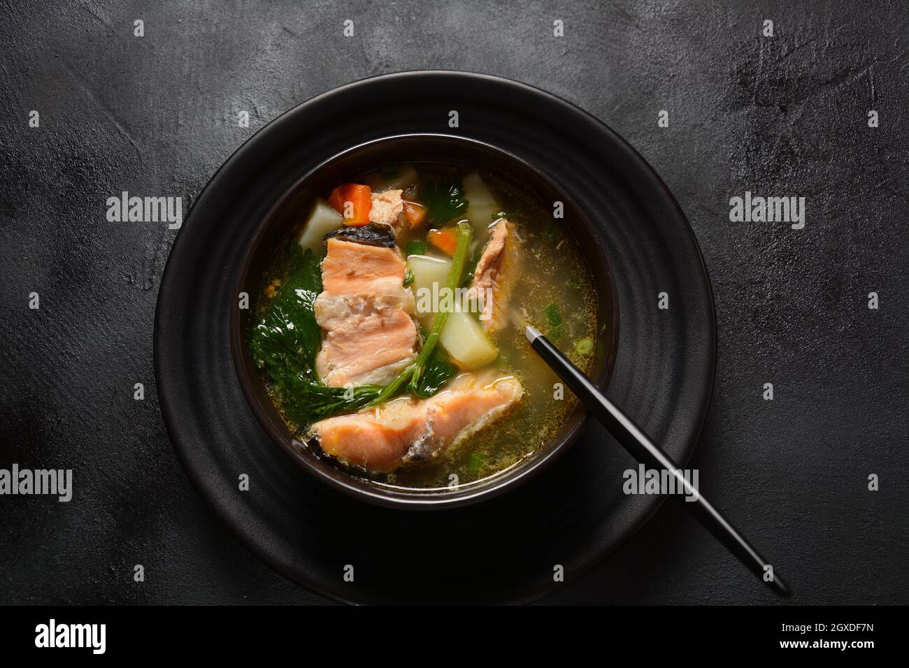 Fresh fish soup on black background. Salmon soup Stock Photo - Alamy