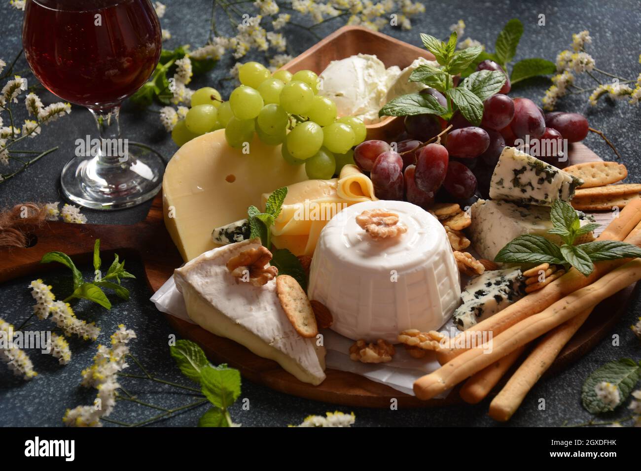 Cheese platter with assorted cheeses, grapes, nuts and snacks . Italian ...