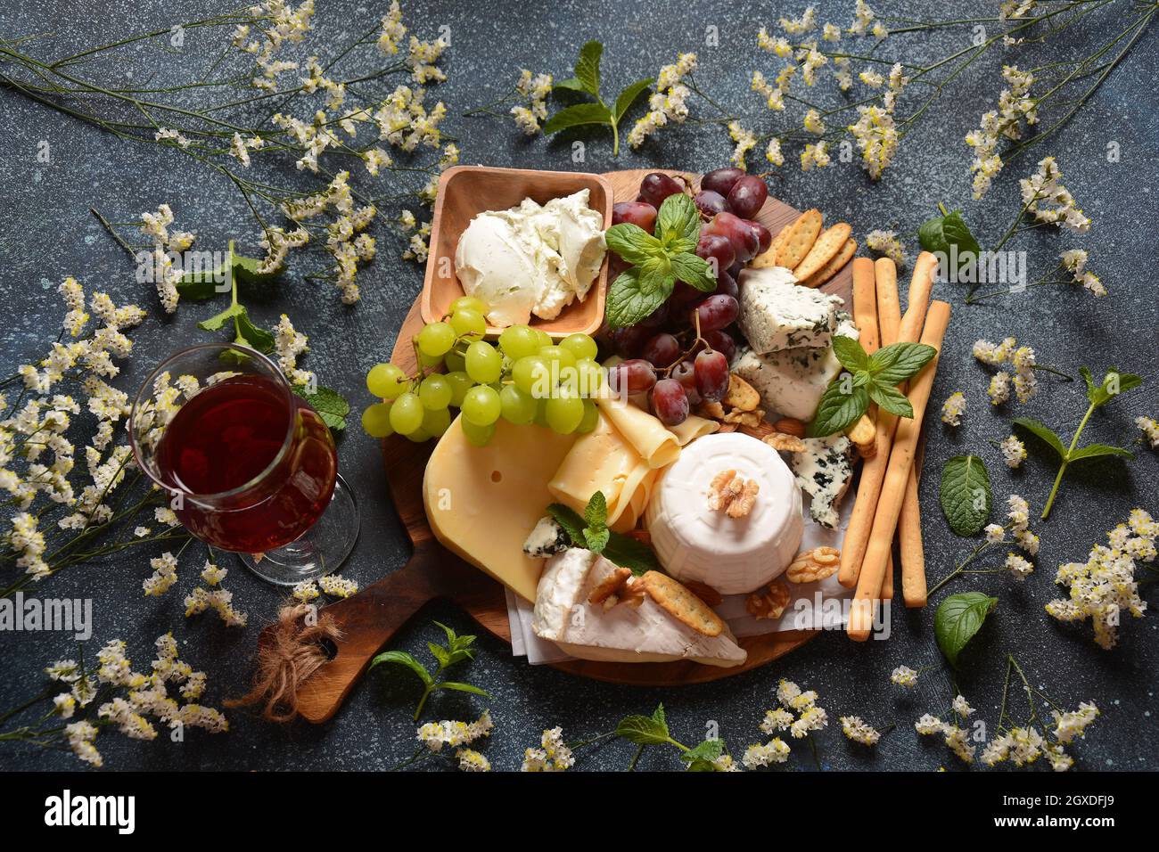 Cheese platter with assorted cheeses, grapes, nuts and snacks . Italian ...