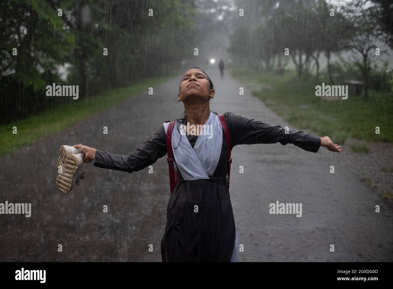 Dhaka, Dhaka, Bangladesh. 5th Oct, 2021. A girl enjoys rain after the ...
