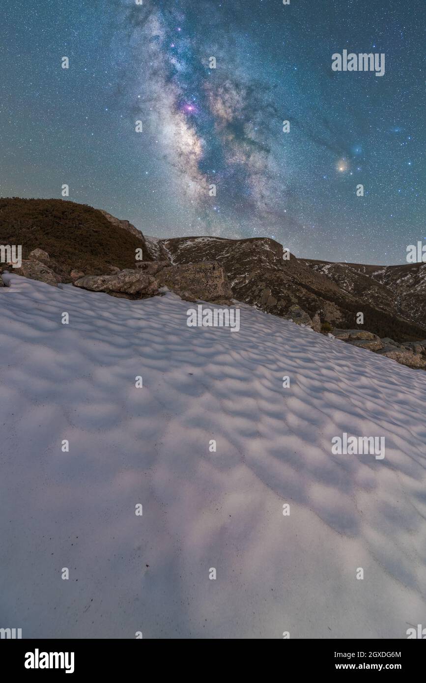 Landscape of snowy valley and mountain under night starry sky with ...