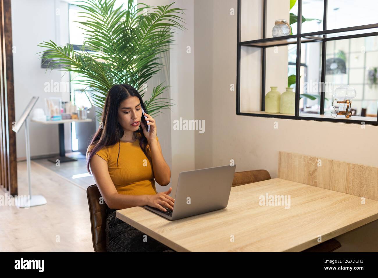 Serious ethnic male with curly hair making pyramid of balls for ...