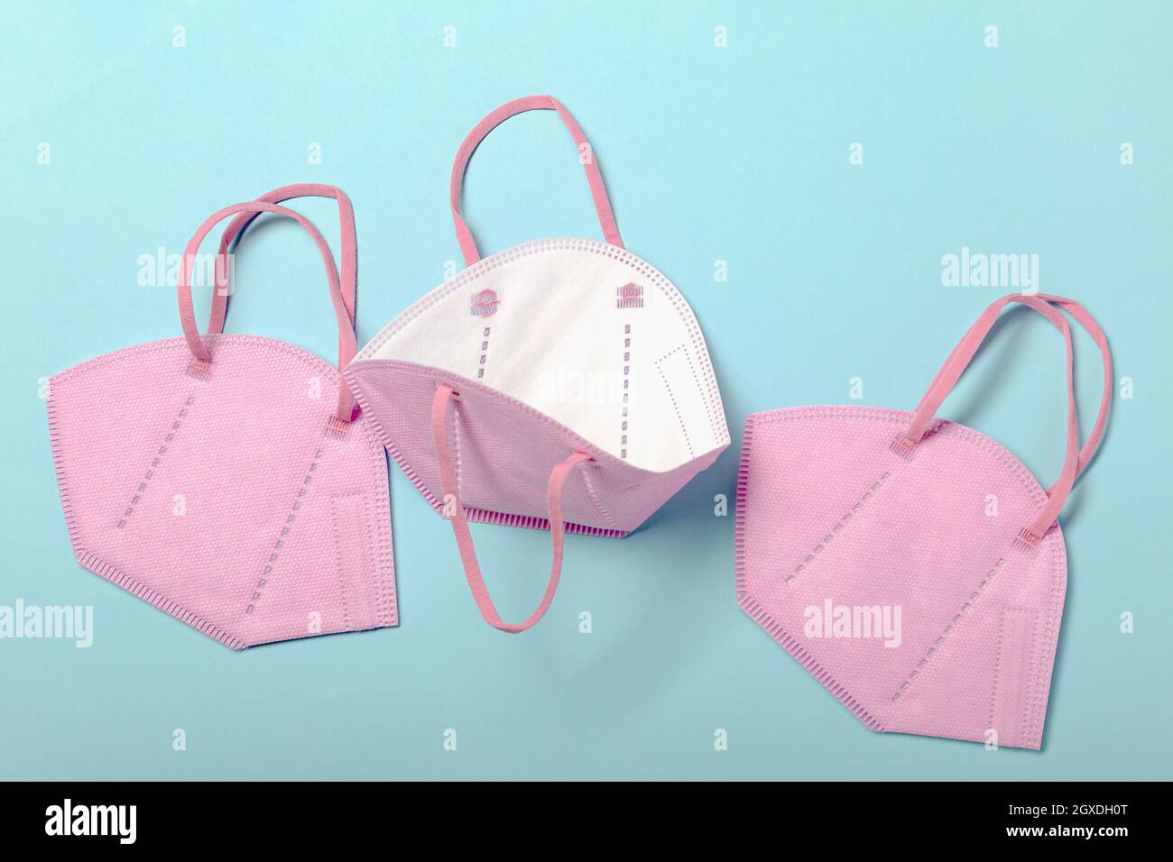 Pink KN95 or N95 FFP2 mask for protection and corona virus on pastel ...