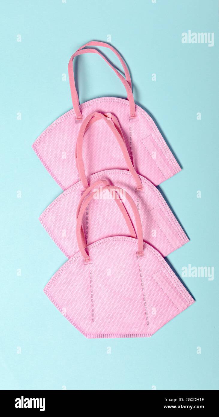 Pink KN95 or N95 FFP2 mask for protection and corona virus on pastel ...
