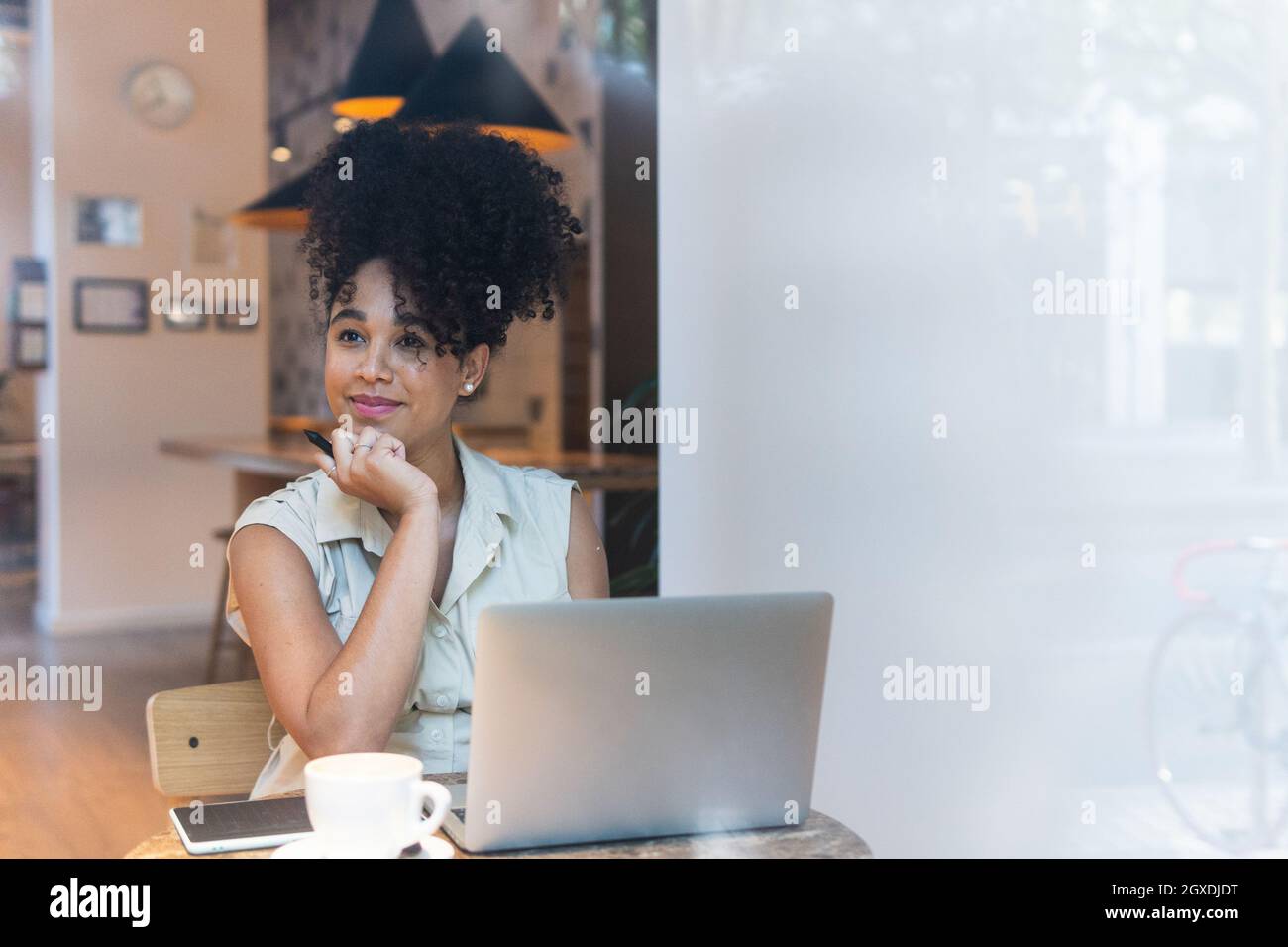 Positive African American female freelancer using graphic tablet at ...
