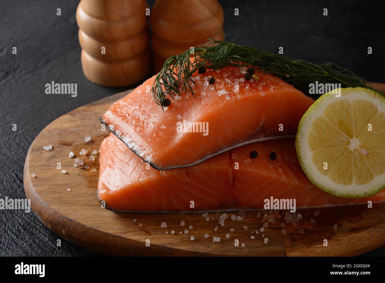 Fresh raw salmon fish fillet with cooking ingredients, herbs and lemon ...