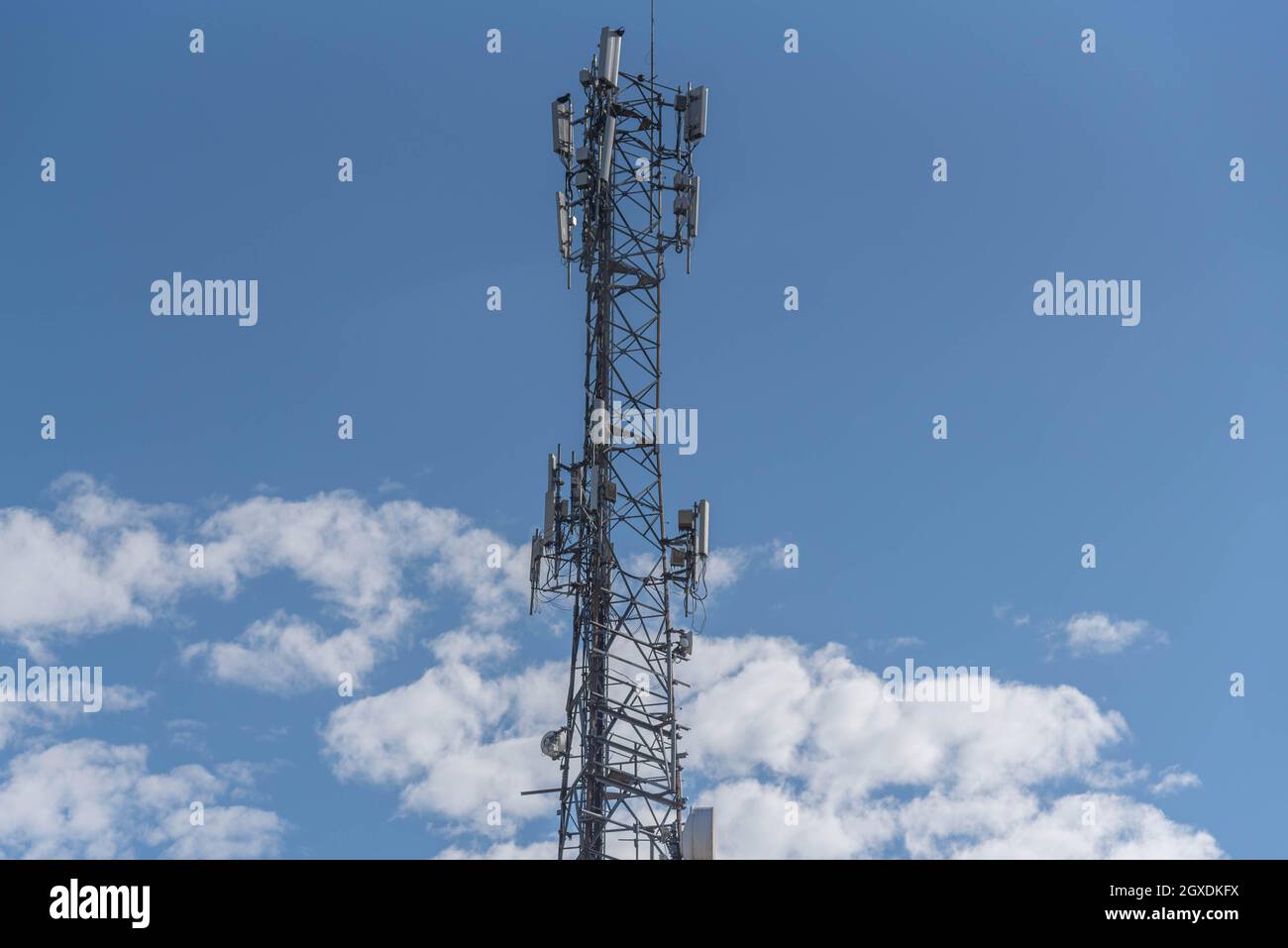 Cell phone data transmission tower on blue natural background ...