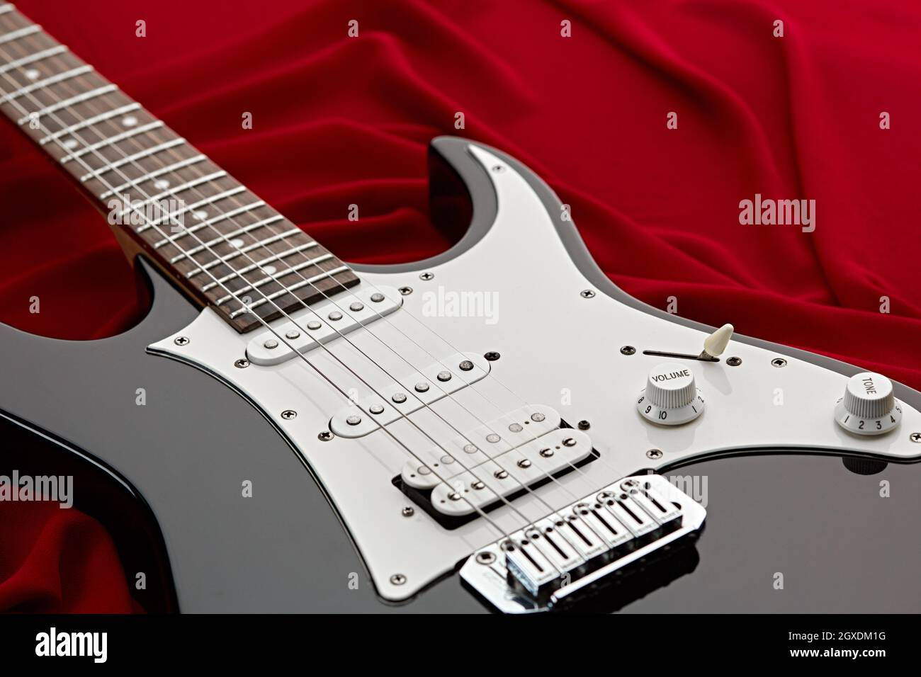 Modern electric guitar, red background, nobody. String musical ...