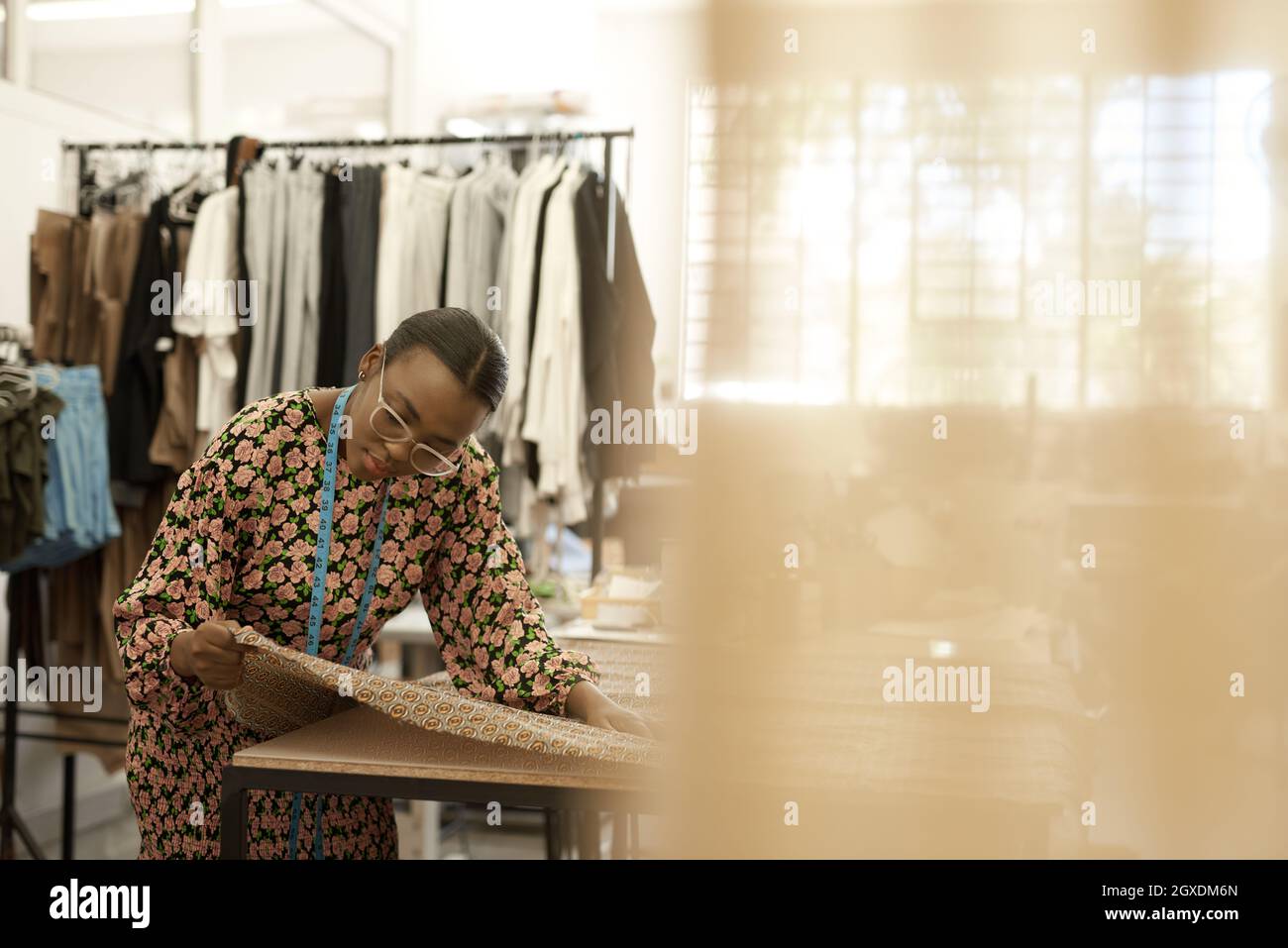 Young fashion designer looking cloth hi-res stock photography and ...