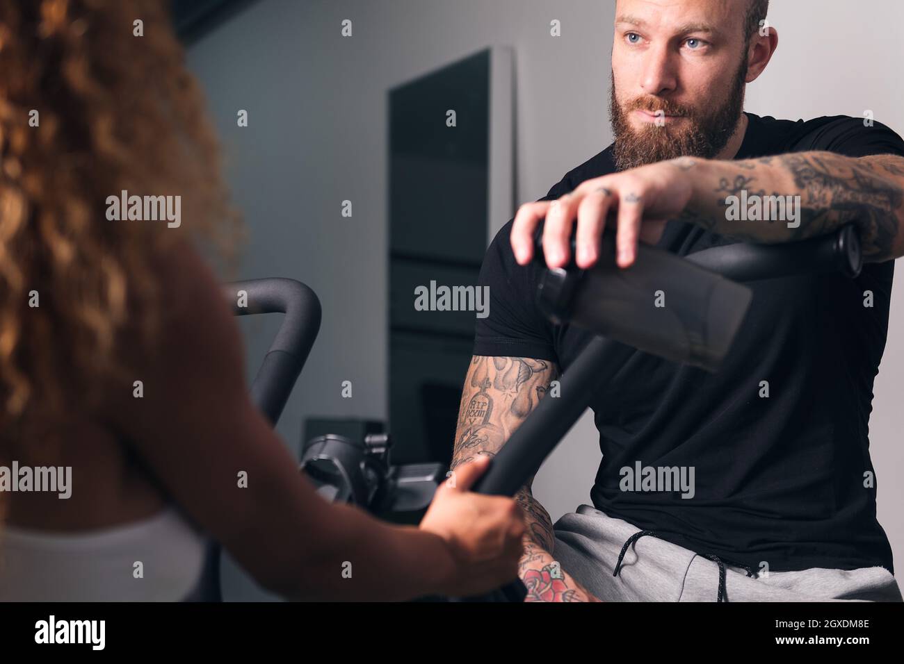 Confident muscular bodybuilder with tattoos speaking against anonymous ...